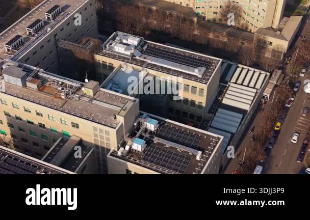 Aerial drone shot slowly descending towards the rooftop of a modern ...