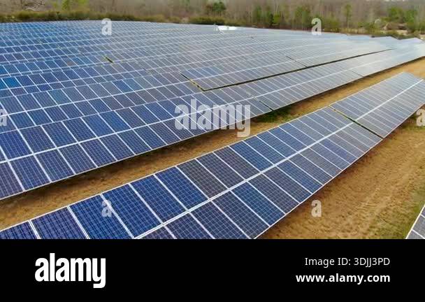 High-angle perspective of a massive solar energy farm. Long rows of ...