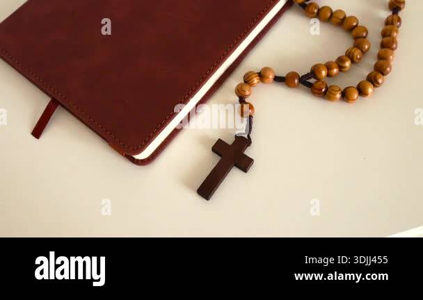 Catholic corner at home. Wooden rosary beads, cross, and prayer book ...