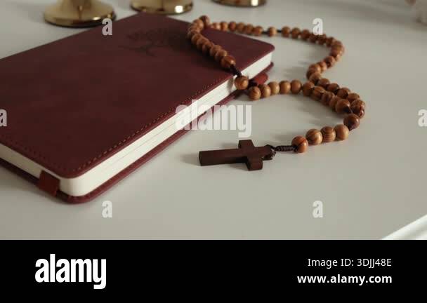 Catholic corner at home. Wooden rosary beads, cross, and prayer book ...