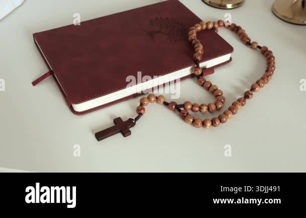 Catholic corner at home. Wooden rosary beads, cross, and prayer book ...