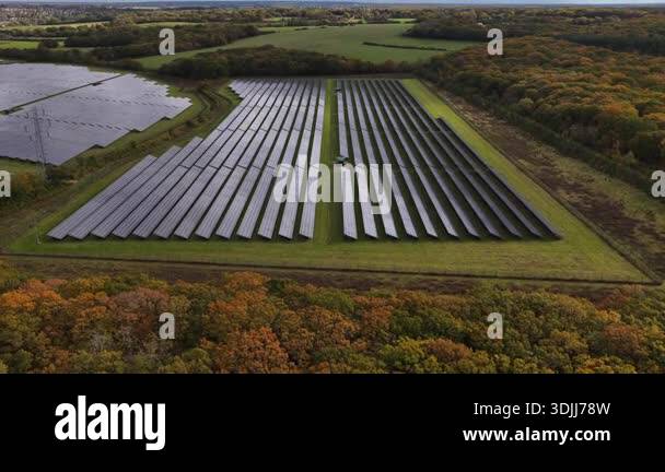 Extensive solar farm with rows of photovoltaic panels generating clean ...