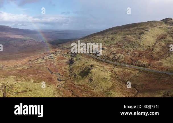 Stunning aerial footage showing a vibrant rainbow arching over a ...