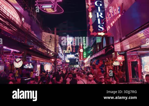 Vibrant neon signs illuminate bustling street full of people in Bangkok ...