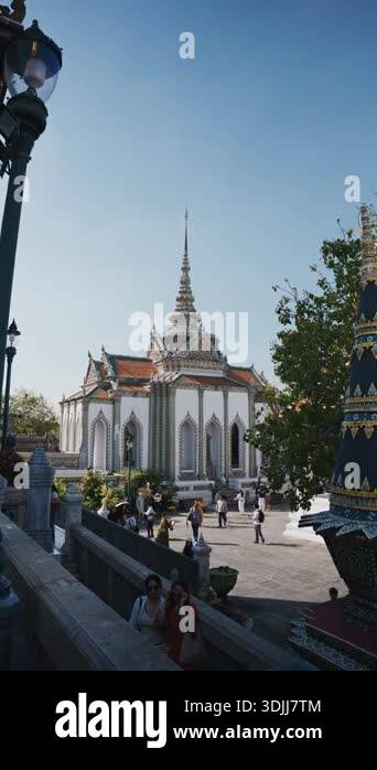 Vertical view of temple inside Grand Palace complex in Bangkok. People ...
