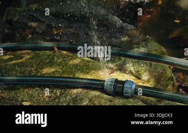 Leaking water pipe on rocky mountain terrain showing challenges of ...