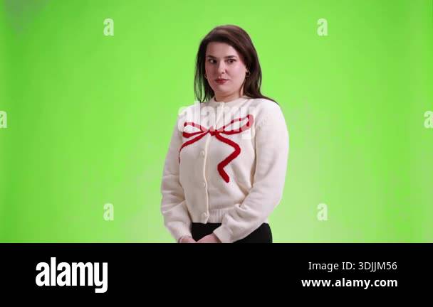 Young woman showing disgust on green screen background with negative ...