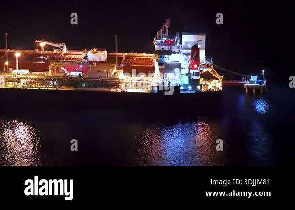 Two tankers lit up at night at marine gas platform Stock Video Footage ...