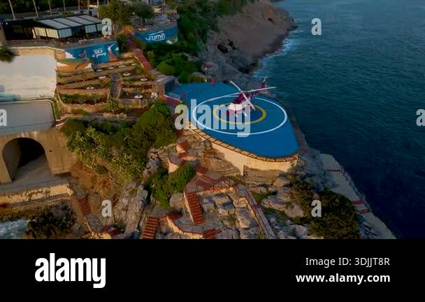Red aircraft on coastal helipad in warm light Stock Video Footage - Alamy
