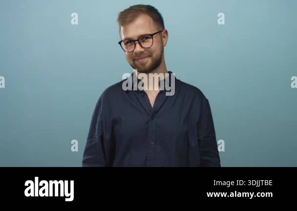 Man with glasses pointing finger in studio against light blue ...