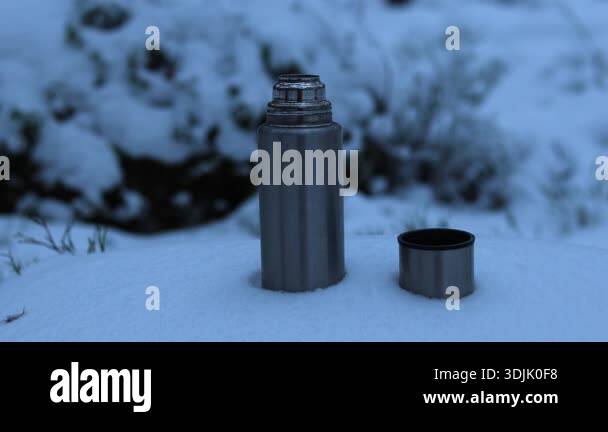 Thermos with hot tea or coffee in the winter forest. 4K video Stock ...