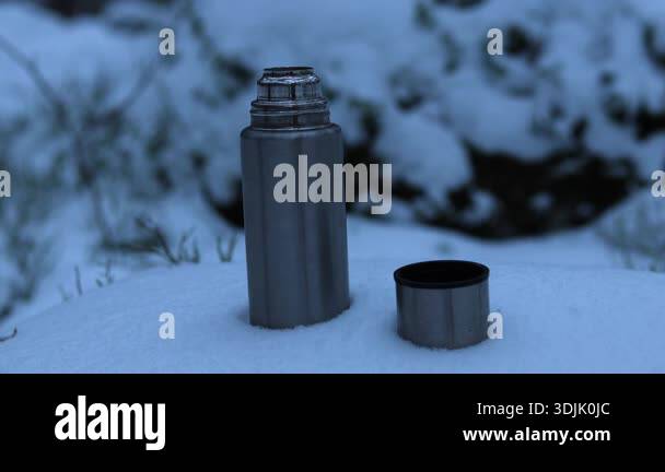 Thermos with hot tea or coffee in the winter forest. 4K video Stock ...