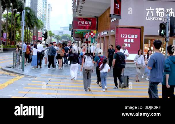Pedestrians crossing a bustling city intersection Stock Video Footage ...