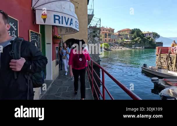 People walking along scenic lakeside path Stock Video Footage - Alamy