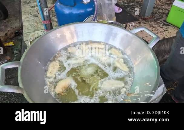 Cooking traditional fried snacks in bubbling oil Stock Video Footage ...