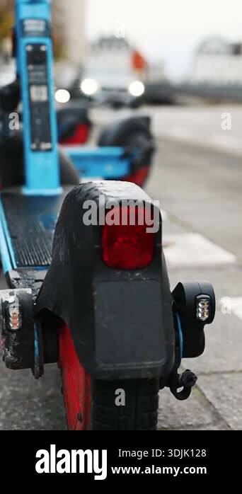 Electric Scooters Standing Against Blurred Background With Passing Cars ...