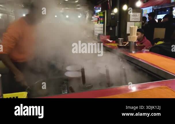 Chef prepares noodles with theatrical smoke effect Stock Video Footage ...