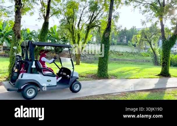 Golf cart moving through lush green golf course Stock Video Footage - Alamy
