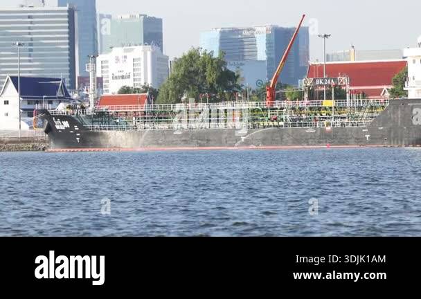 Cargo ship moving along the city's river edge Stock Video Footage - Alamy