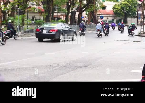 Motorcycles and cars navigate a bustling intersection Stock Video ...