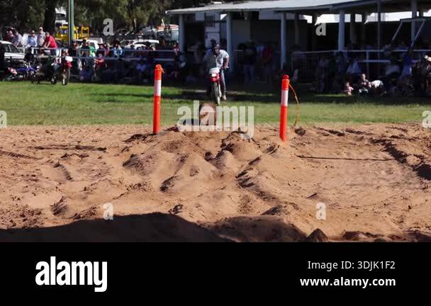 Motorcycle jumping over dirt mound in race Stock Video Footage - Alamy