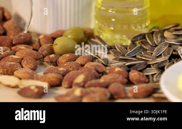 Various high-fat foods including nuts, seeds, olive oil, butter ...