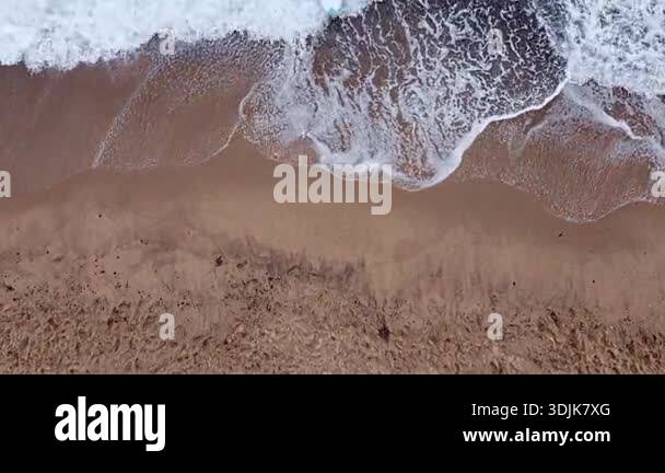 Aerial view from above of a person on a paddleboard at the seashore ...