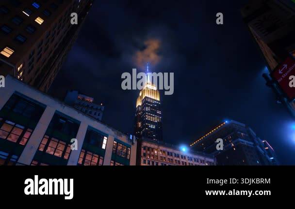 Luminous Empire State Building with neon top from low angle perspective ...