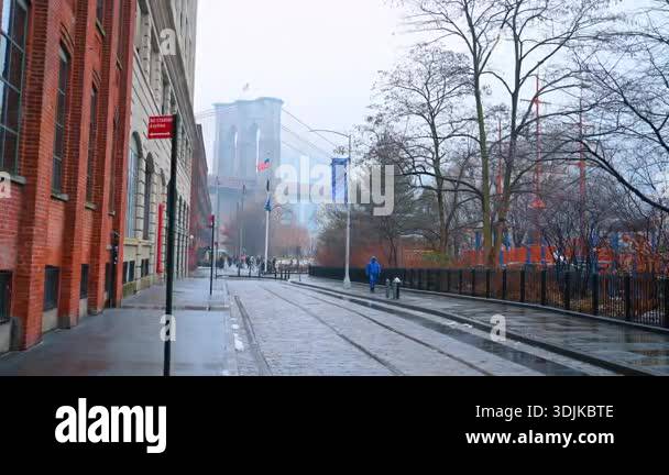 New York, USA, 24 December 2025: Brooklyn Bridge in fog over East River ...