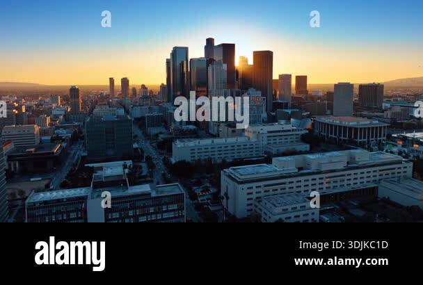 Setting sun shines brightly behind the skyline of modern metropolis ...