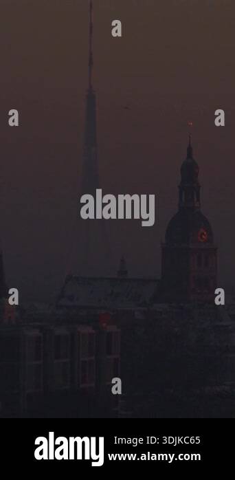 Riga, Latvia at dusk shows Riga Cathedral clock and Riga Radio and TV ...