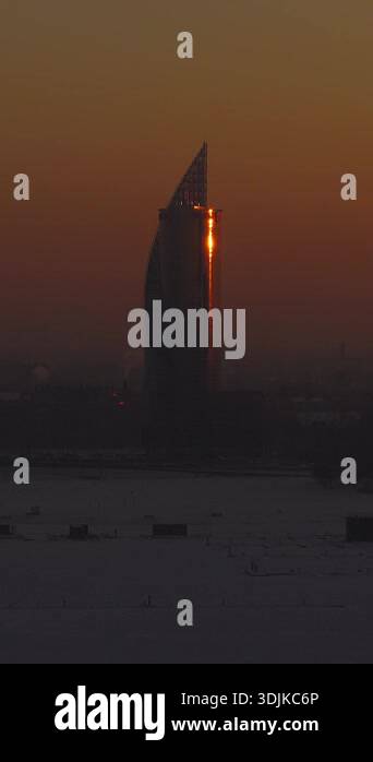 A sail shaped glass skyscraper in Riga stands near the Daugava River at ...