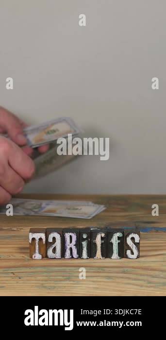 Hands Handling Cash Above Table While TARIFFS Represent Import Export ...