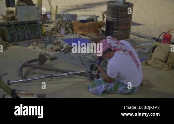 Doha , Qatar- December 7 2024: A traditional Arabic blacksmith working ...