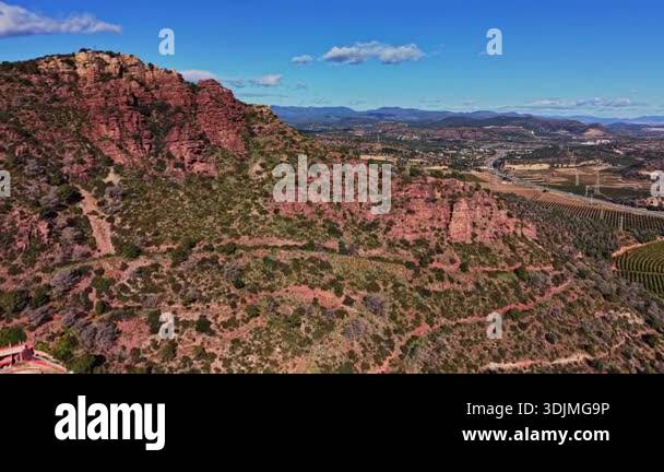 A vast view of the Sierra de Collserola mountains in Spain shows rocky ...
