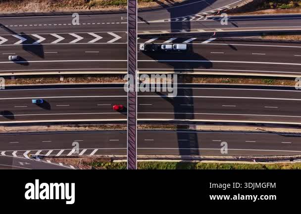Cars are driving on a busy highway in Spain. The image shows multiple ...
