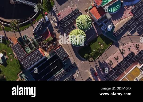 Solar panels lie on rooftops in Spain. The scene shows green domes and ...