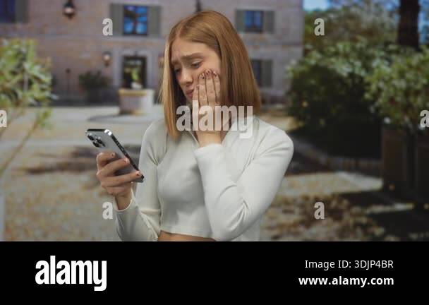 Woman outdoors in old town street feeling sad while looking at ...