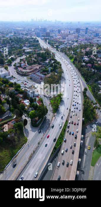 Drone aerial view of busy highway curving through Los Angeles ...
