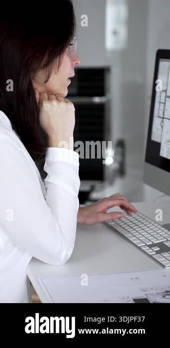 Woman architect planning architectural project, working on blueprints ...