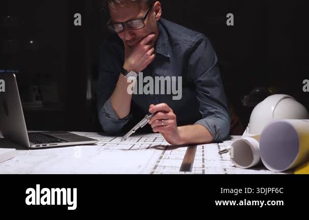 Stressed architect feeling headache and frustration, working late at ...