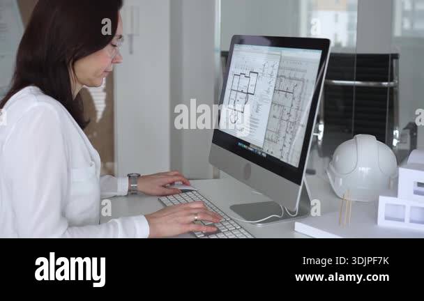 Architect designing building plans on computer, collaborating on ...