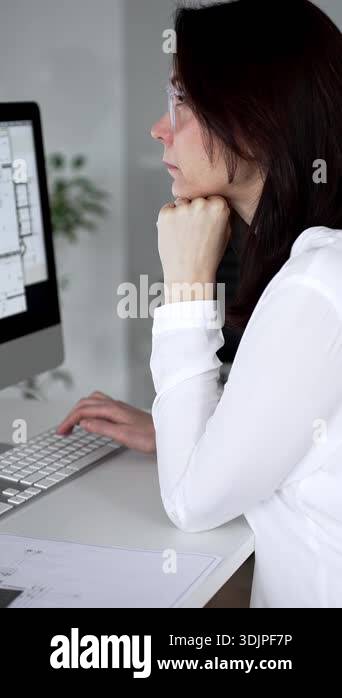 Woman architect planning architectural project, working on blueprints ...