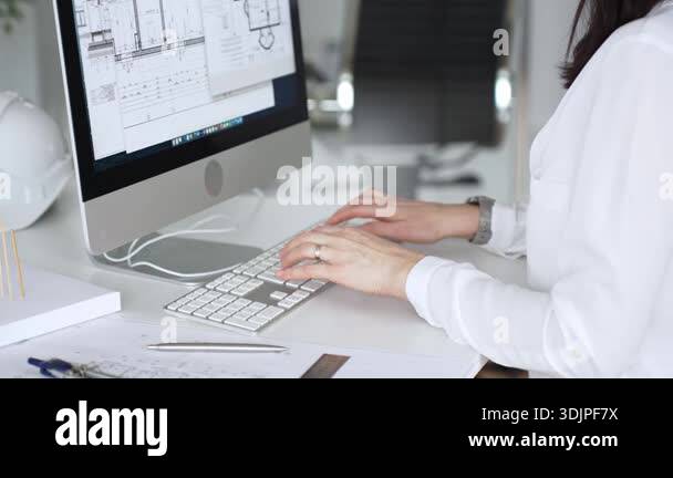 Woman architects hands typing on keyboard, manipulating mouse, working ...