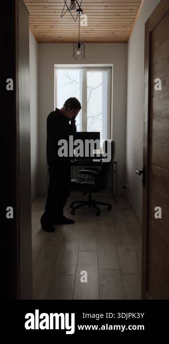 Man receiving bad news on phone in home office, slow motion, stress and ...