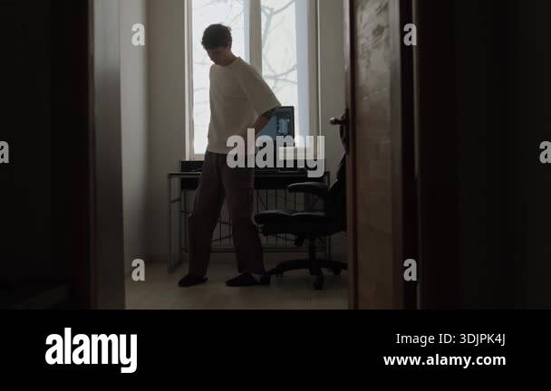 Man taking stretching break in home office, doing simple workout near ...