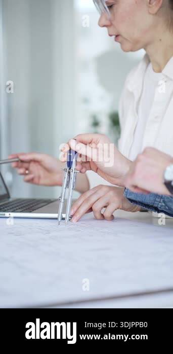 Architects collaborating on a project, analyzing technical drawings and ...