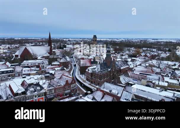 Aerial view of a snowy european historic city featuring several ...