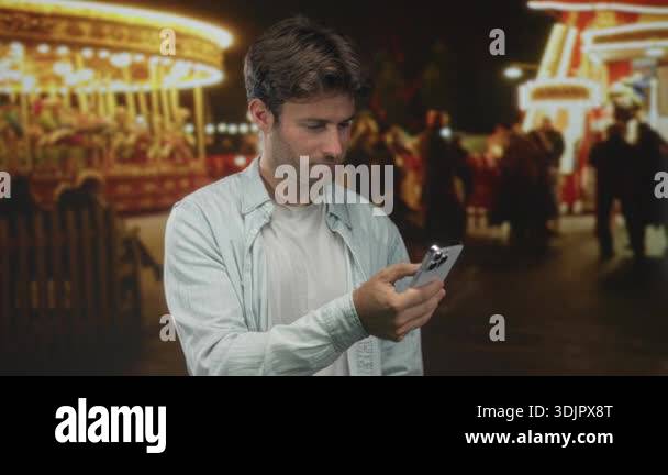 Man holding smartphone, tapping screen with right hand, visible face at ...