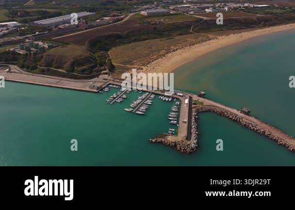 Wide aerial shot of Vasto port with calm sea, harbor infrastructure and ...